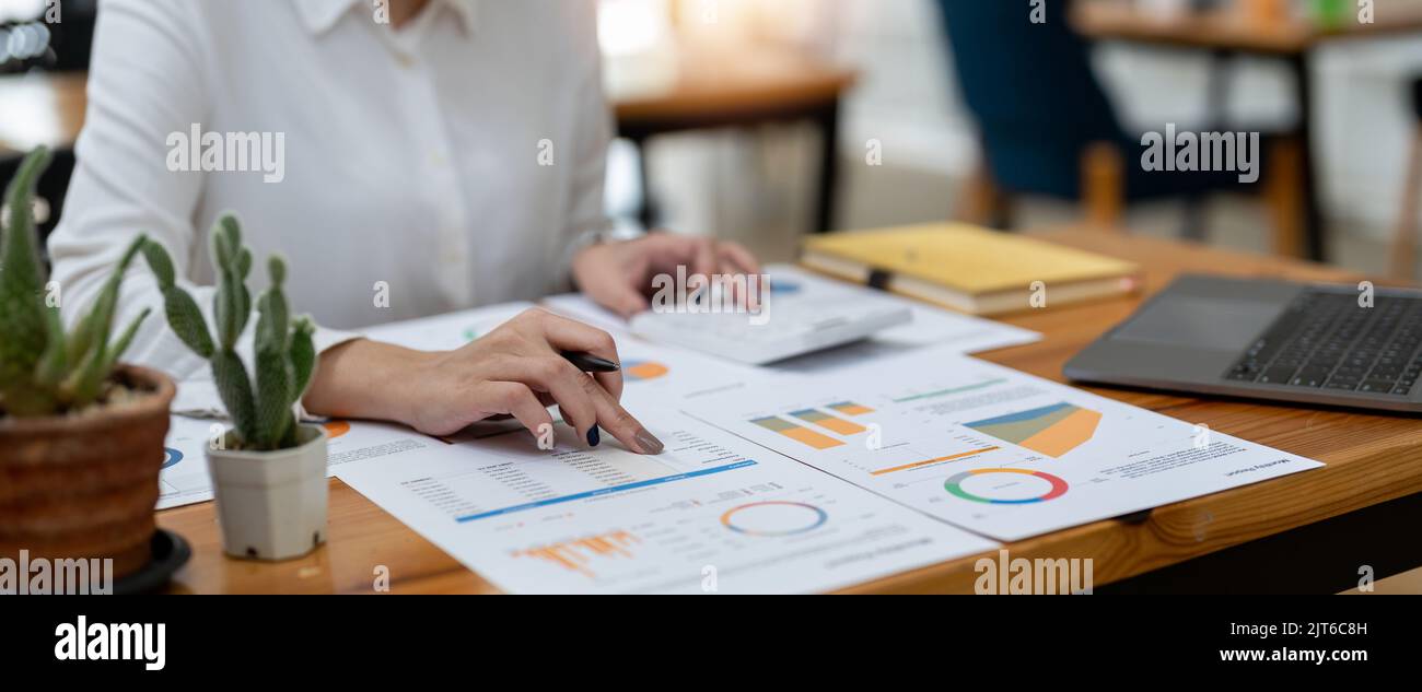 Woman accountant working with computer and calculator for business and ...