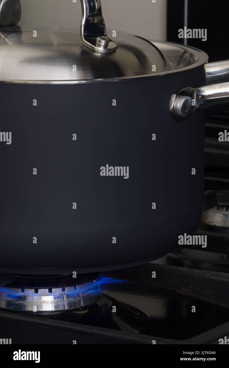 A black pan cooking on natural gas. Concept for gas crisis Stock Photo ...
