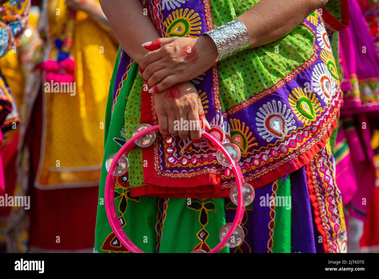 Indian woman in colorful clothes during a holiday on a street in a city ...