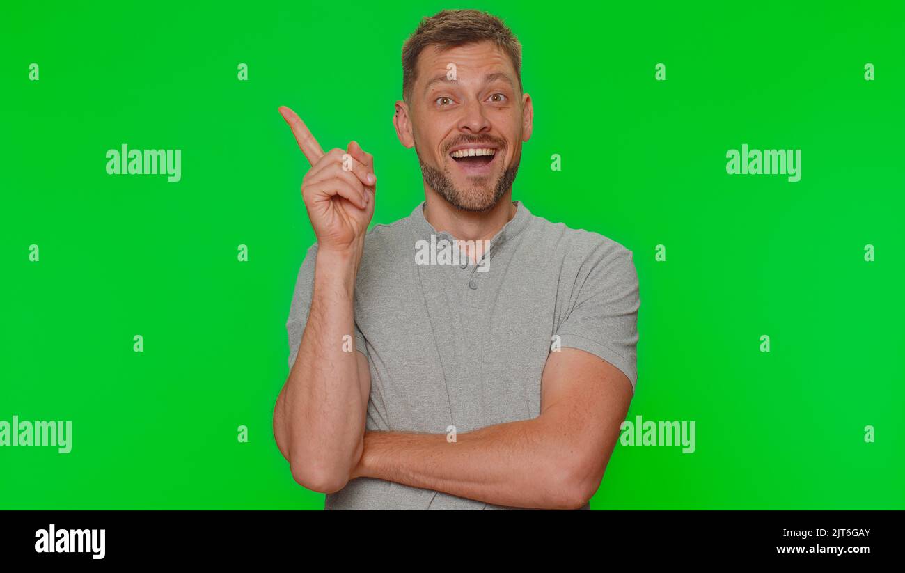 Eureka. Inspired man pointing finger up with open mouth, having good ...