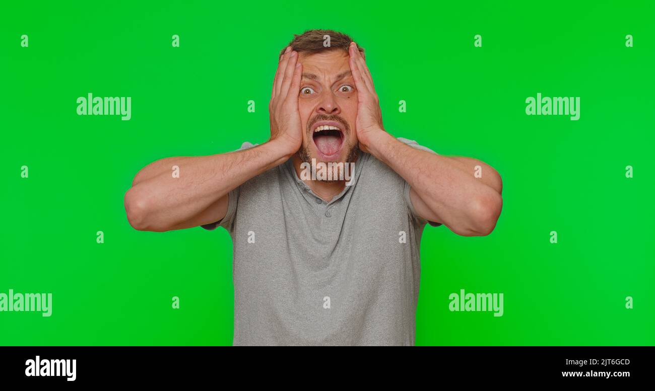 Angry sad young man screams from stress tension problems feels horror ...