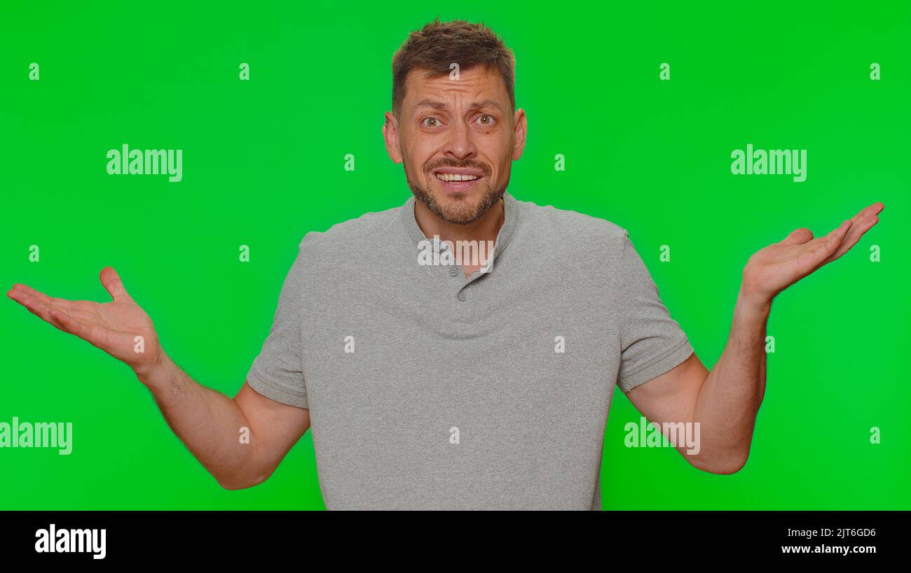 What, Why. Handsome young man raising hands in indignant expression ...