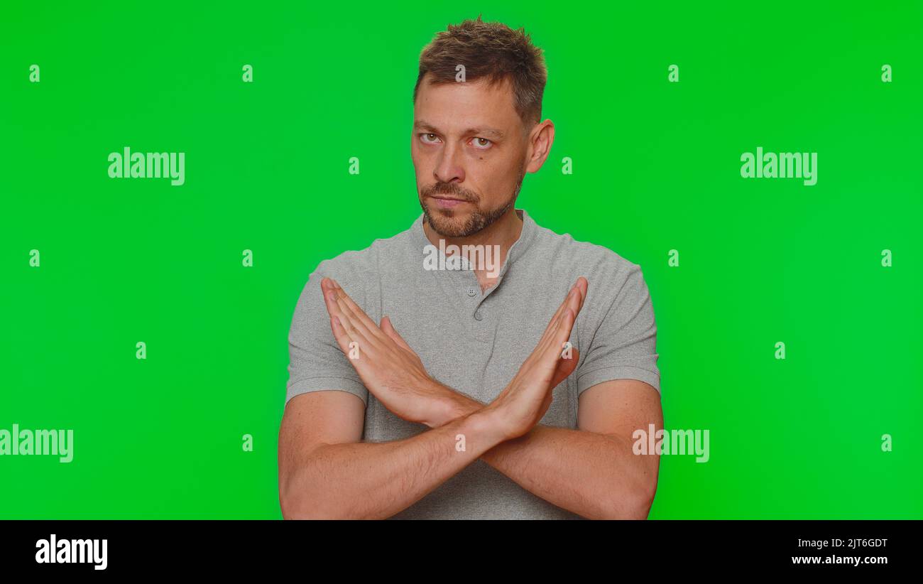 Stop. Young man say No hold palm folded crossed hands in stop gesture ...