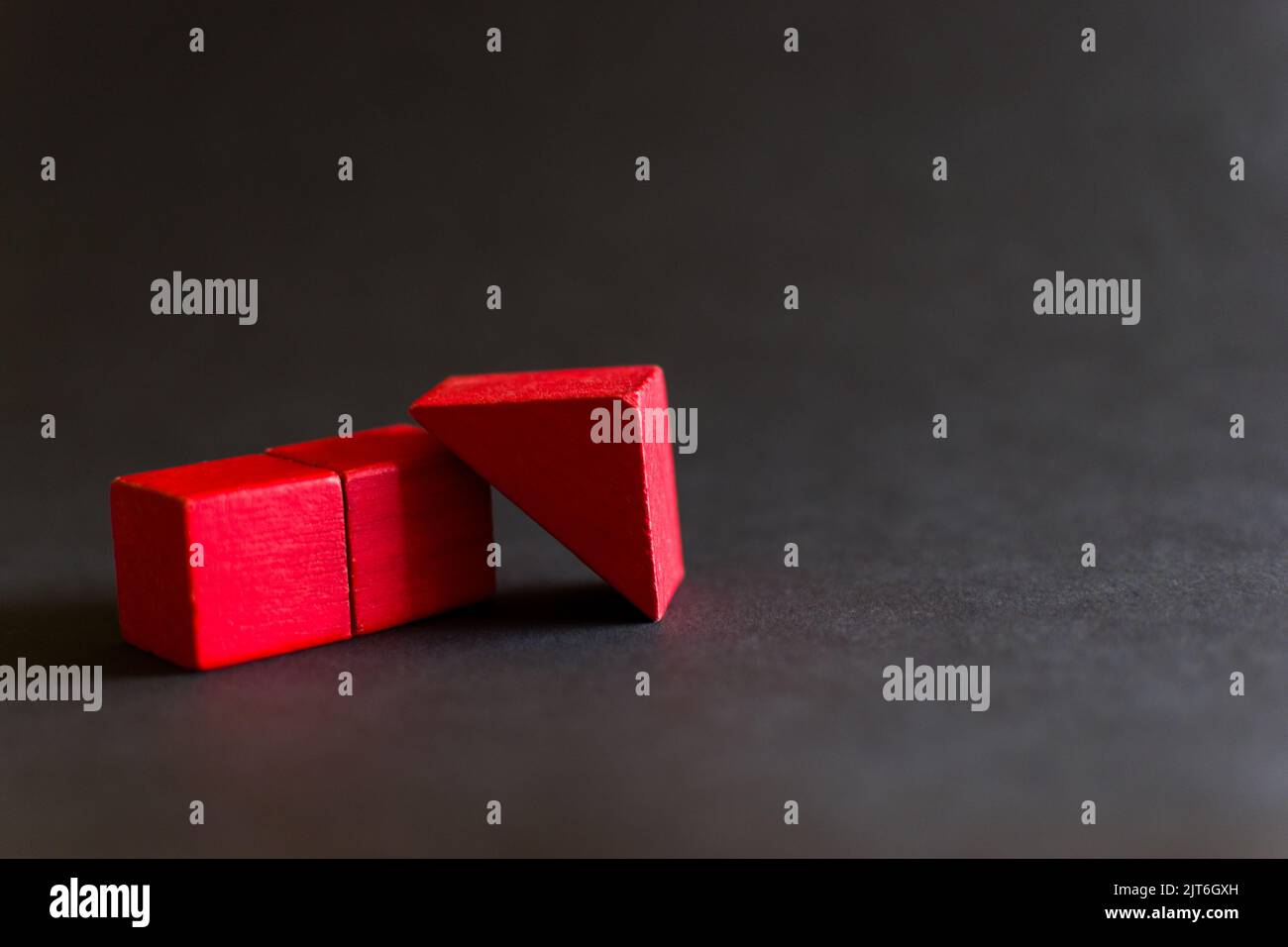 Collapsed red toy wooden house on black background with copy space ...