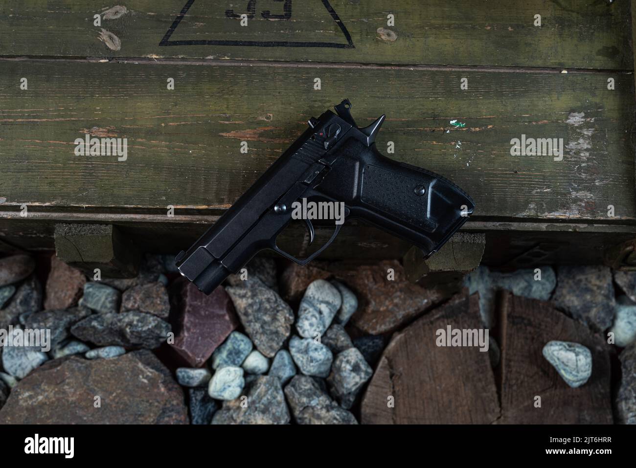 Short barrel. Combat pistol on a wooden army box. Firearm pistol. View ...