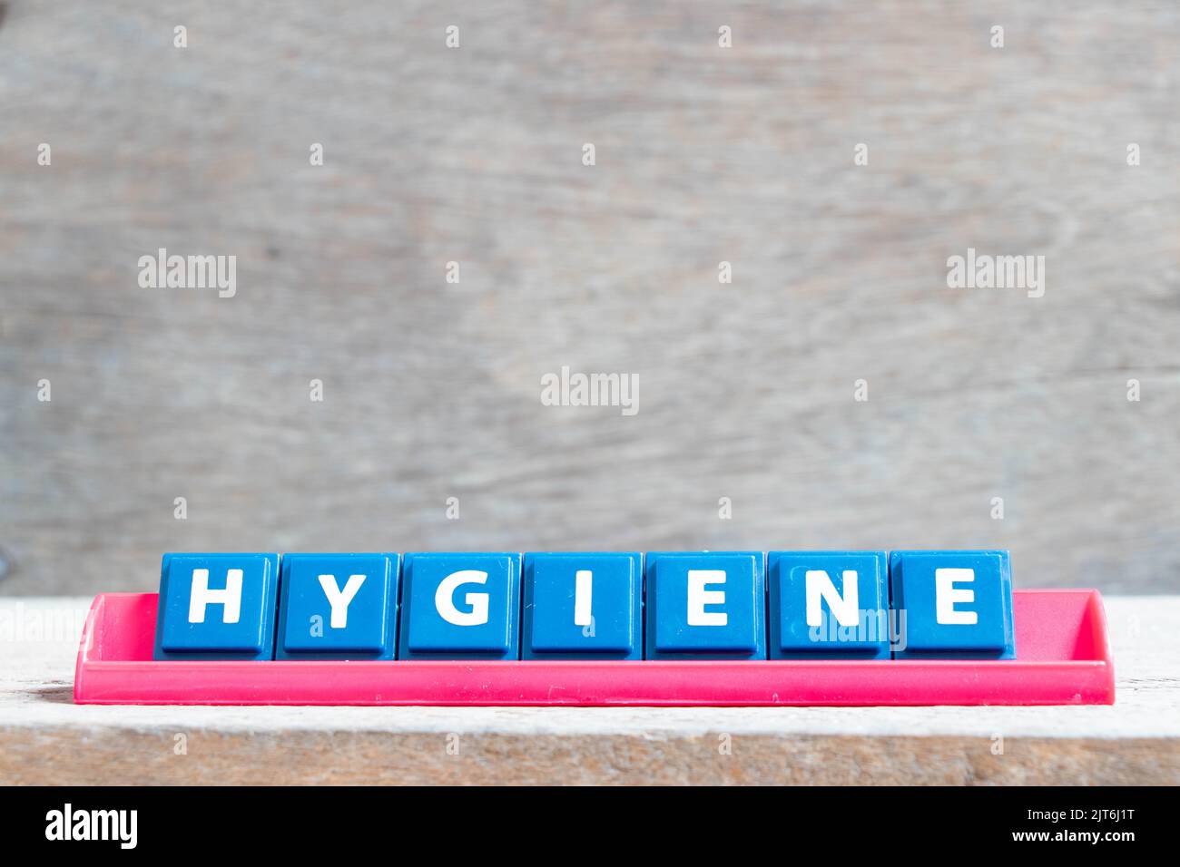Tile alphabet letter with word hygiene in red color rack on wood ...
