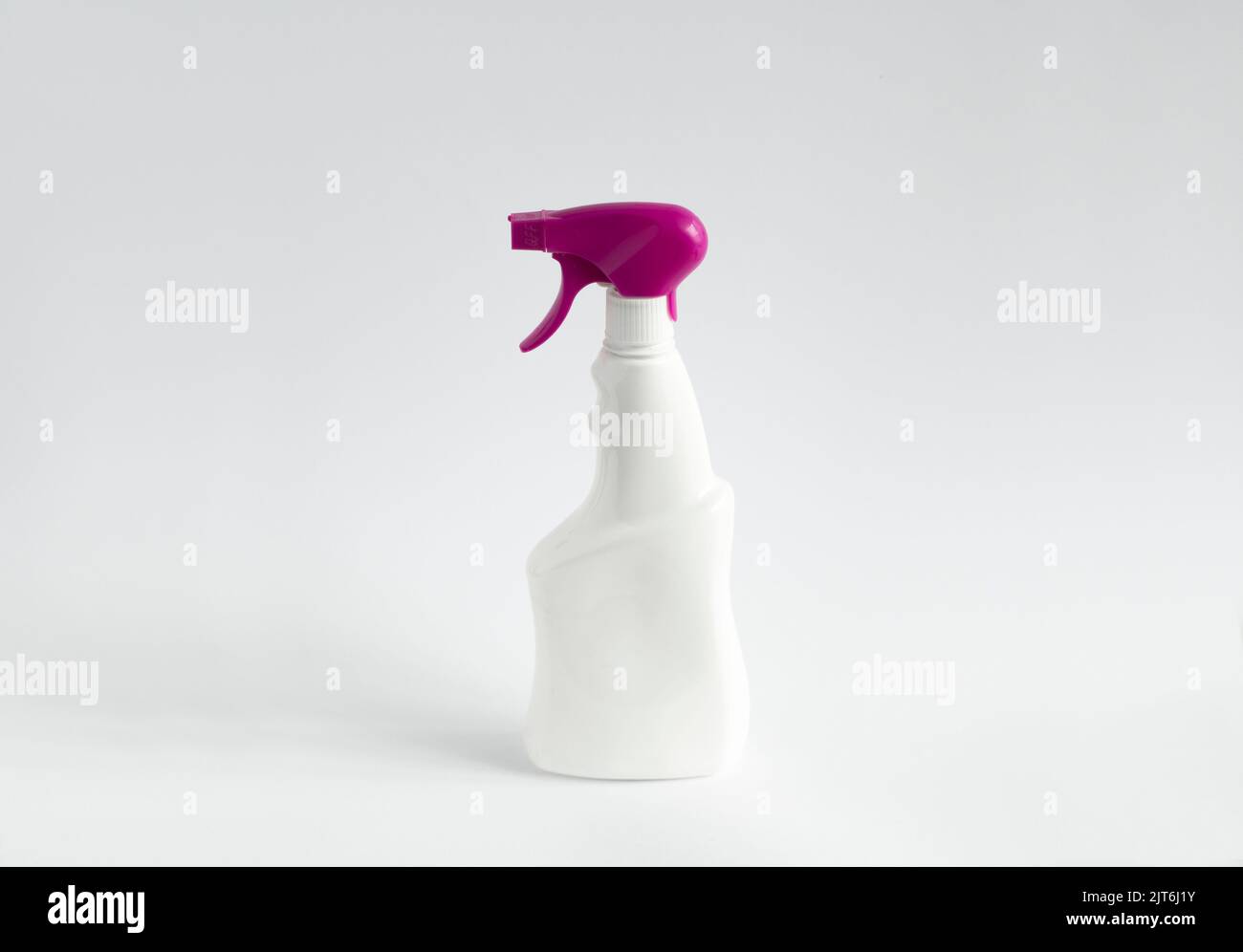 White detergent bottles or chemical cleaning supplies with a violet ...