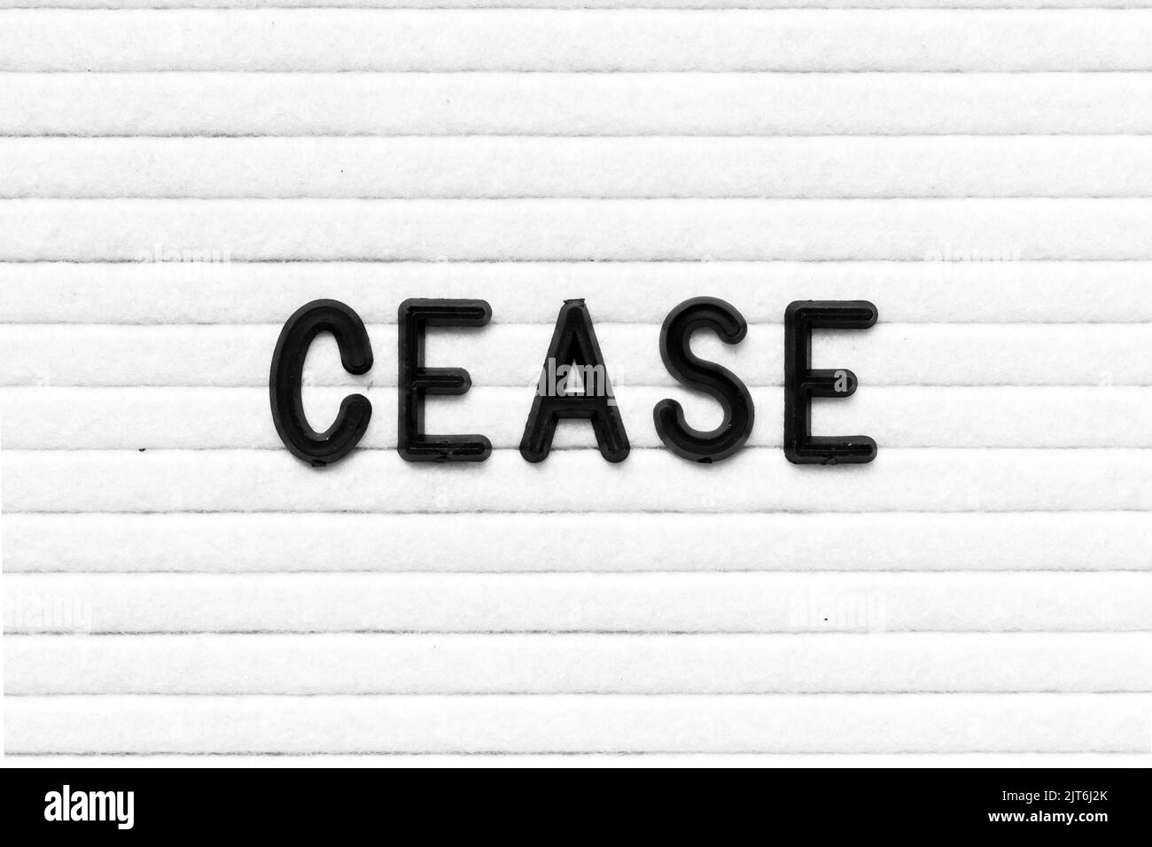 Black color letter in word cease on white felt board background Stock ...