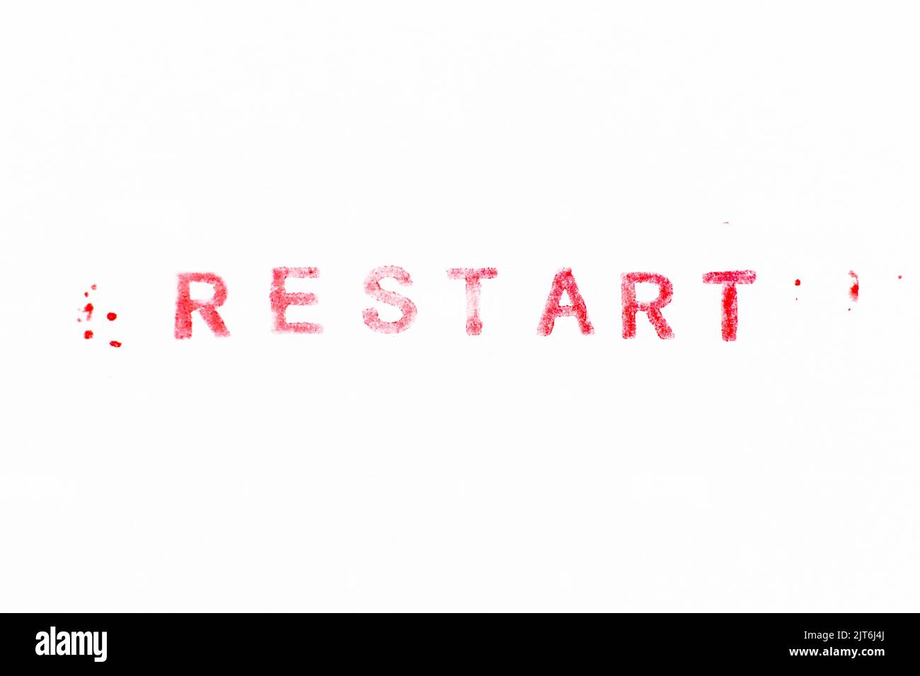 Red color ink rubber stamp in word restart on white paper background ...