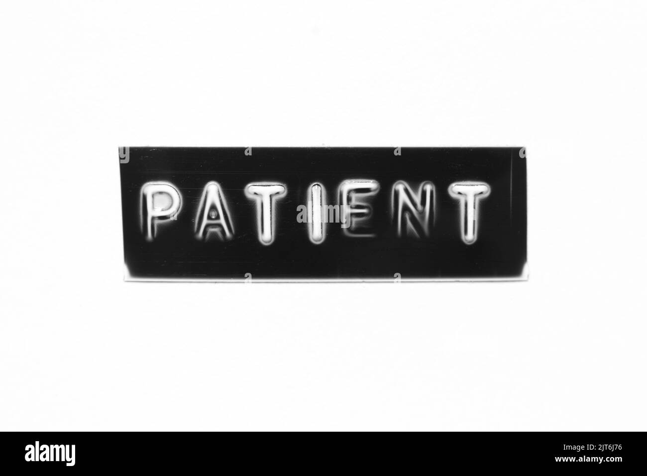 Black color banner that have embossed letter with word patient on white ...