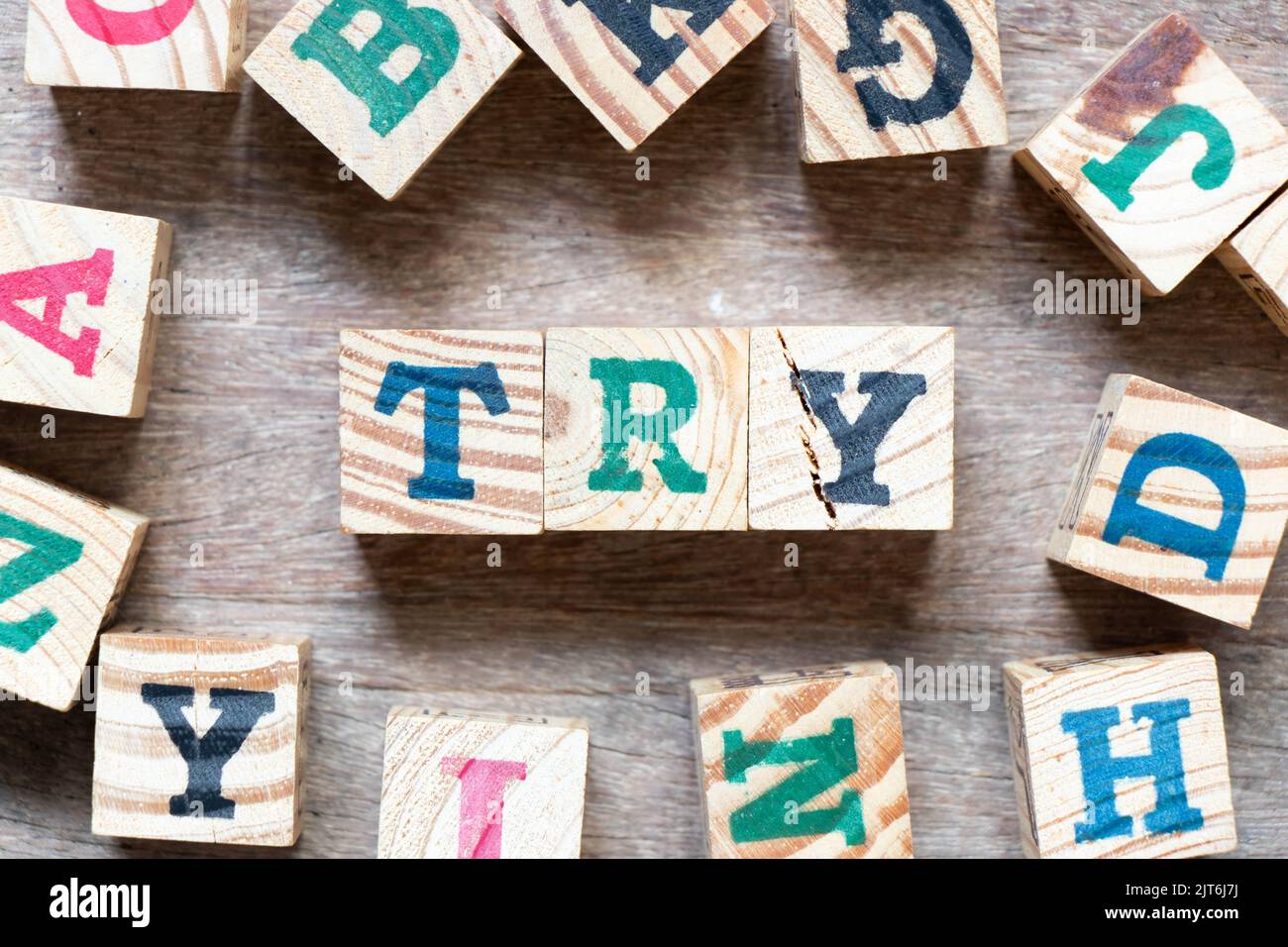 Alphabet letter block in word try and another letter on wood background ...