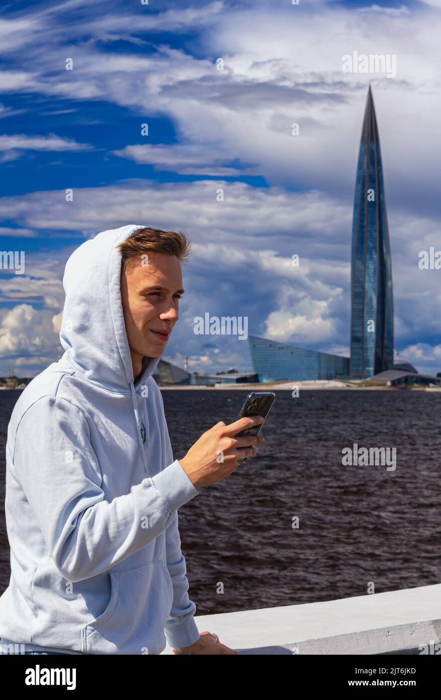 Handsome guy video calling online and talking while standing near ...