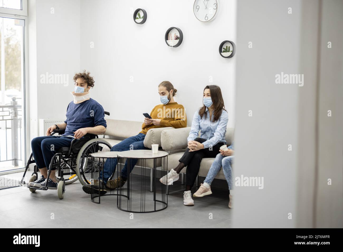 People sitting in the hall of the clinic, waiting for an appointment ...