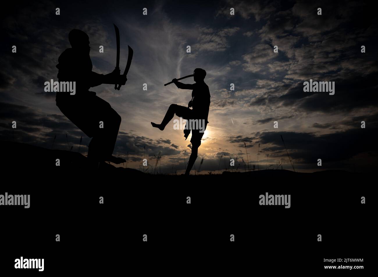 Martial arts sword fighting silhouettes at sunset Stock Photo - Alamy