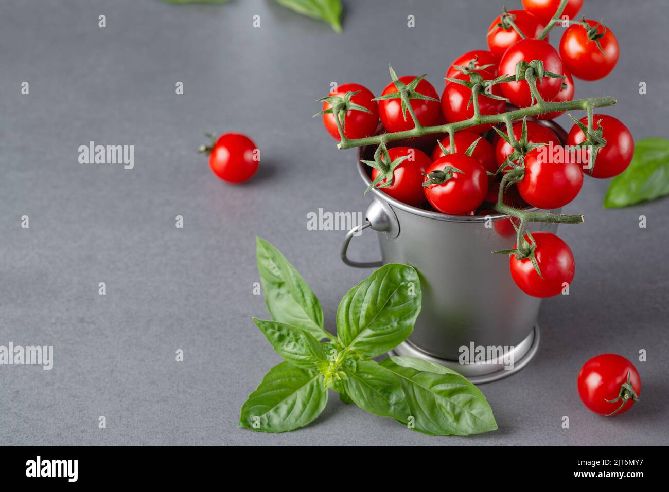 Metal bucket with red ripe cherry tomatoes Stock Photo - Alamy