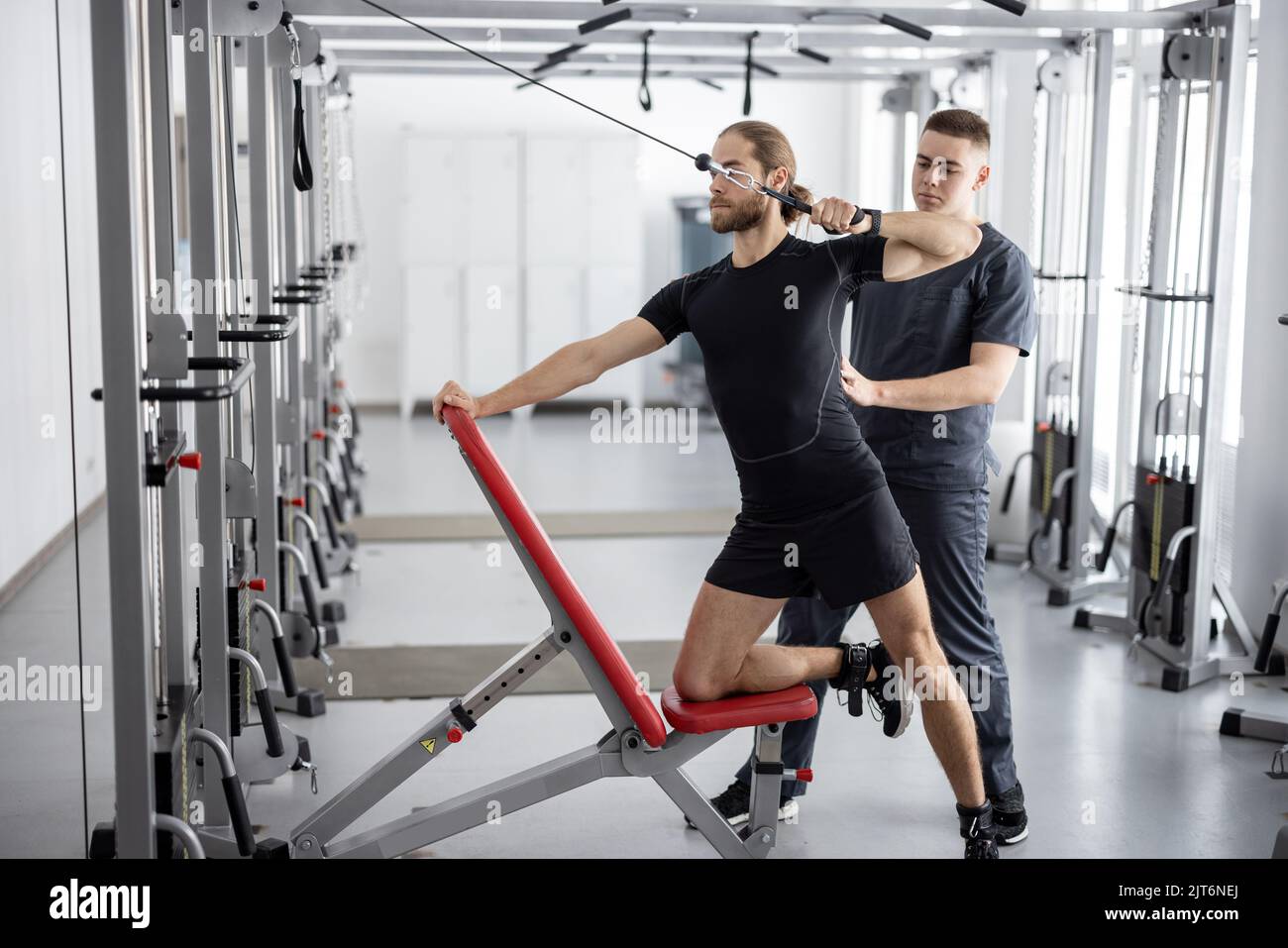 Man doing exercises on decompression simulators with the help of ...