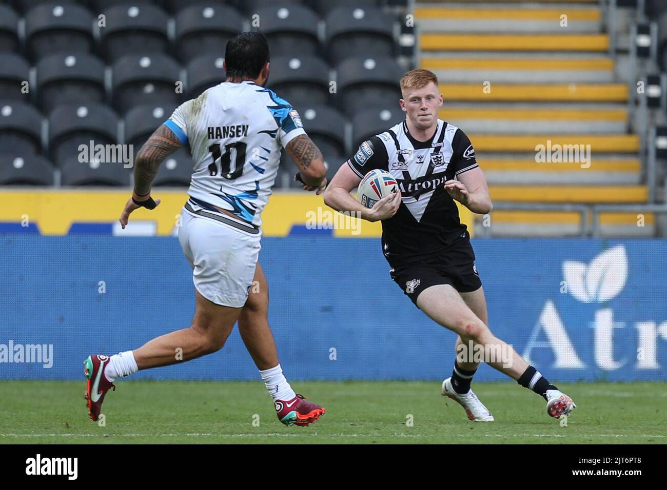 Harvey Barron #32 of Hull FC looks to run at Harrison Hansen #10 of ...