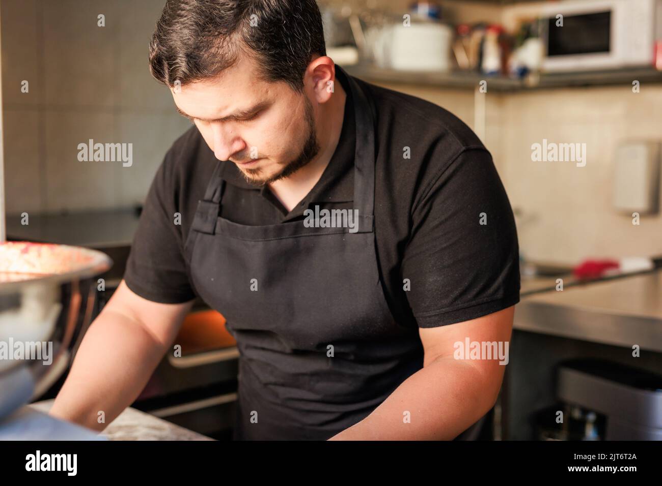 Latin Pizzeria chef cook pizza in professional uniform. restaurant ...