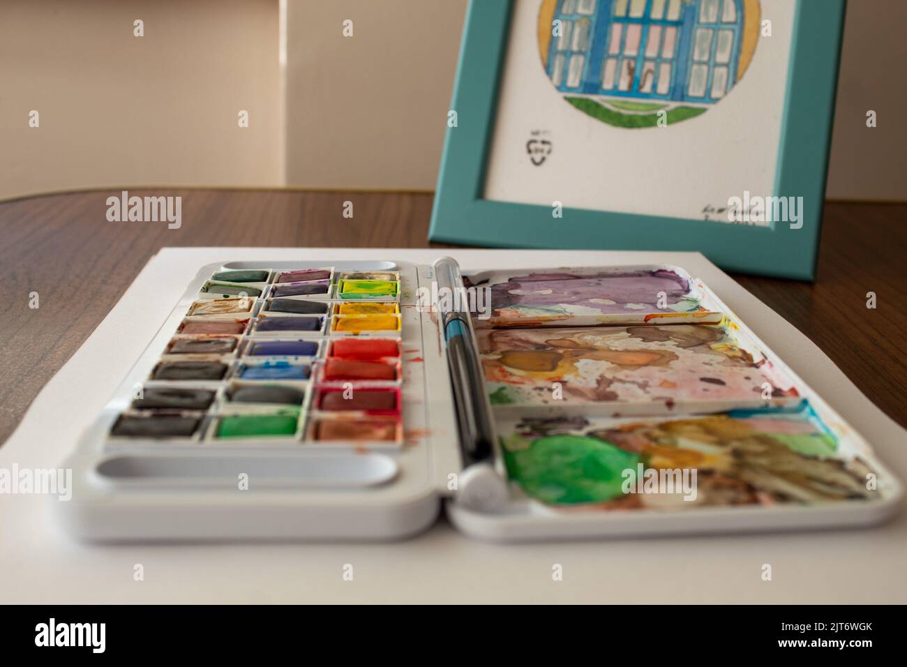 Colorful watercolor palette and brush close-up, back to the school ...