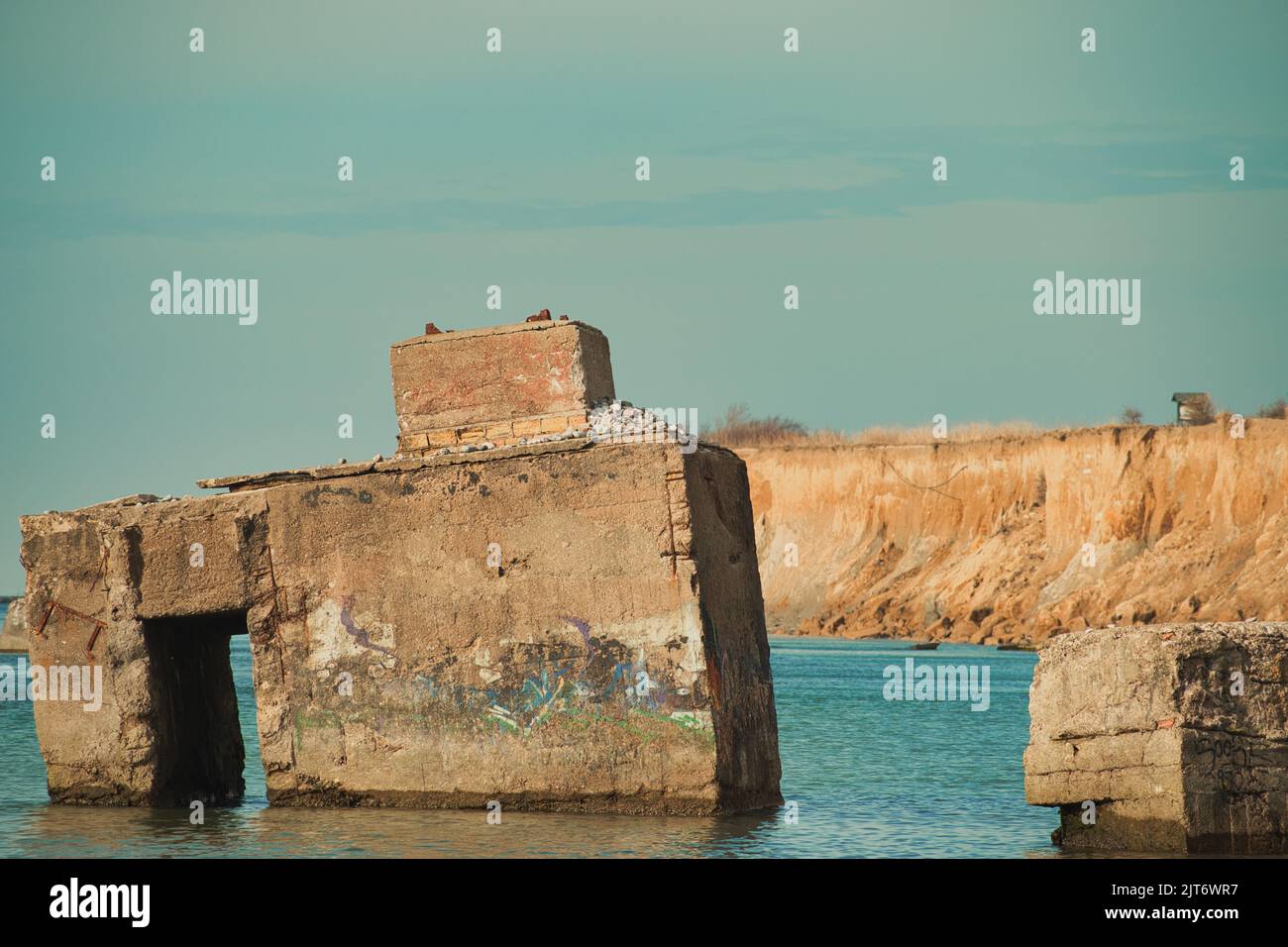 A small stone bomb shelter on shore of a tranquil sea Stock Photo - Alamy
