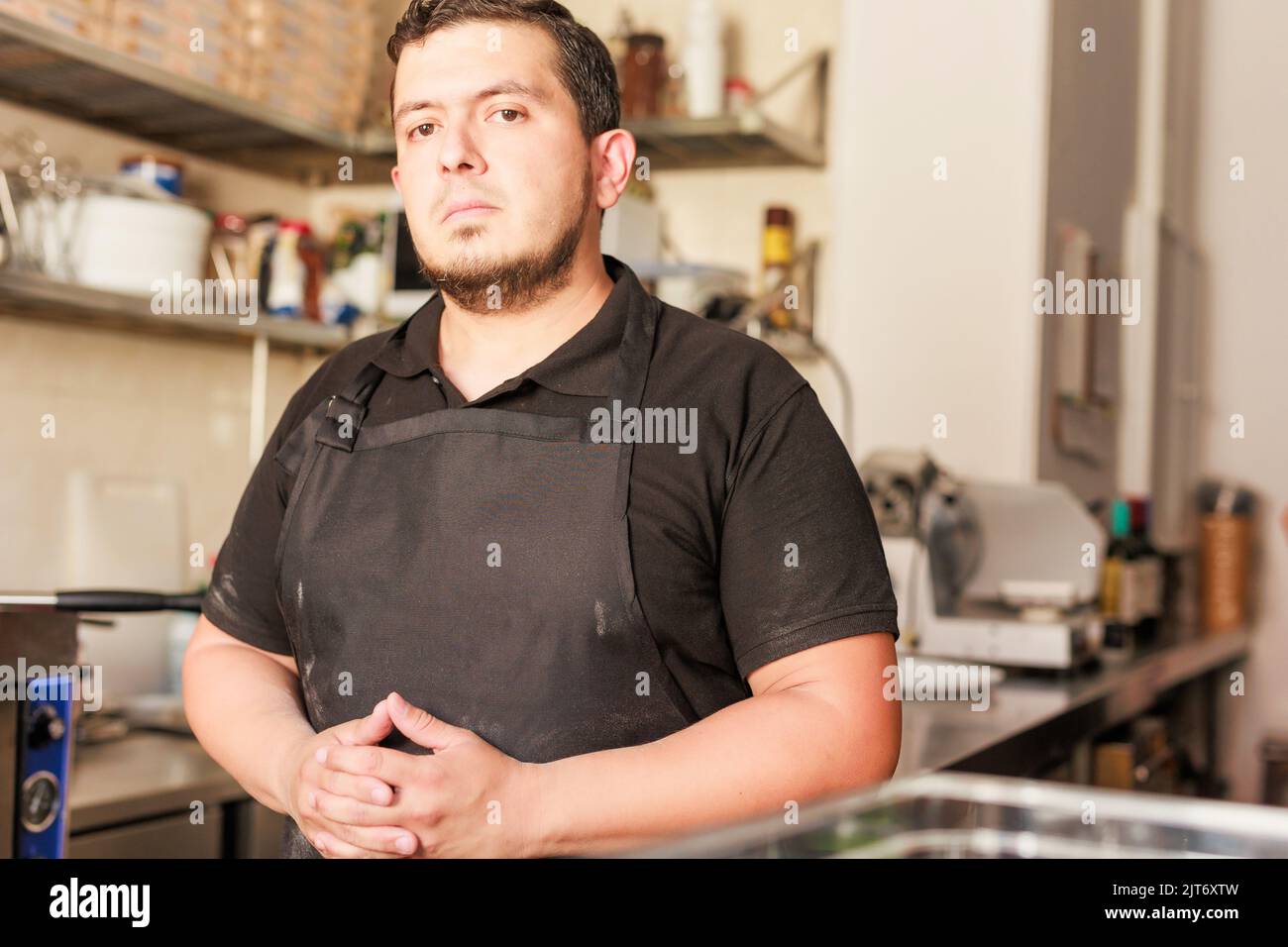 Latin mid chef entrepreneur with professional uniform. successful owner ...