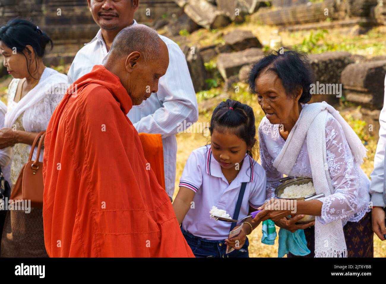 The Buddhist monks collecting alms at a ceremony in rural Takeo ...