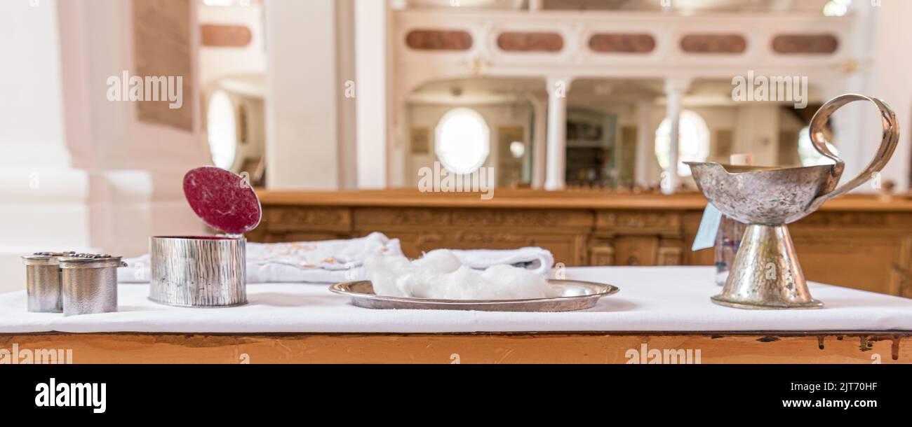 chrisam oil in a vessel and holy water in a bowl. Preparation for the ...