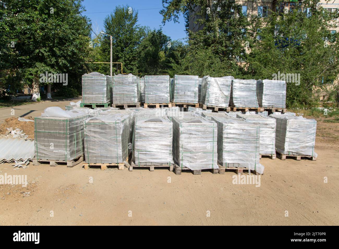 Building materials in packaging lie on wooden pallets row at the ...