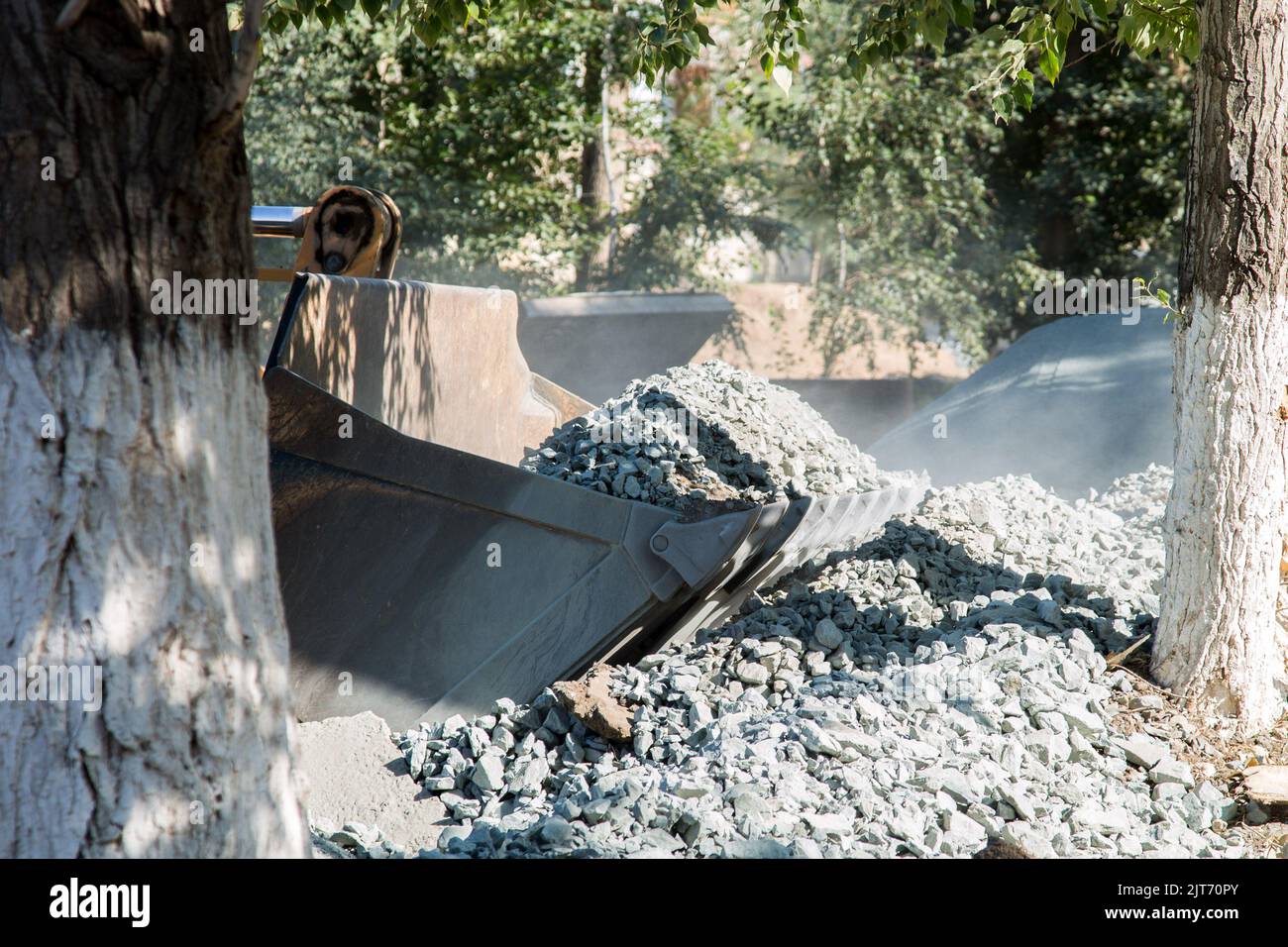 Construction loader bucket filled with rubble at construction site ...