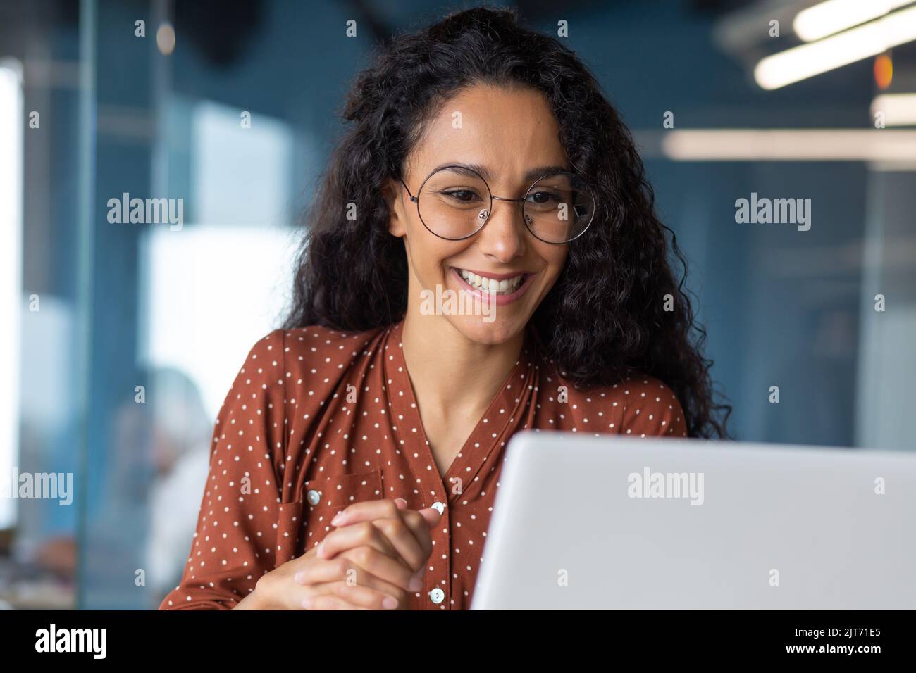 Close-up photo of young beautiful business woman with curly hair and ...
