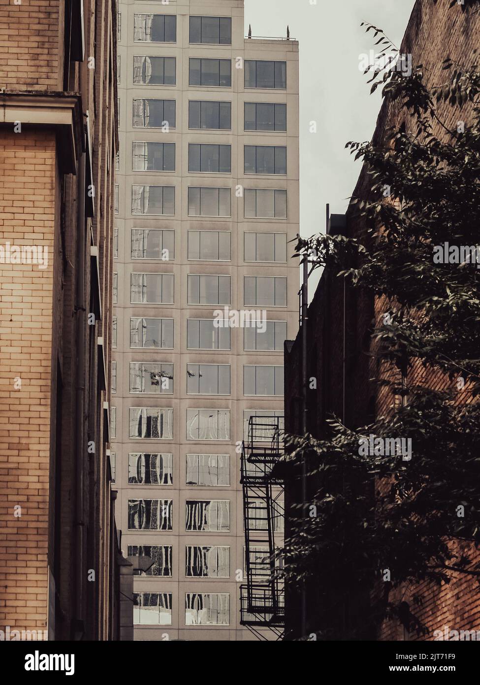 Vintage style image urban buildings at end and on sides of alleyway in ...