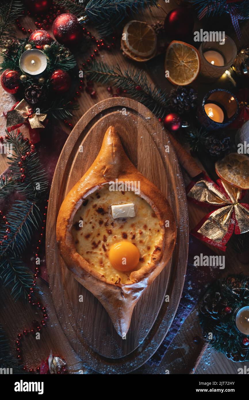 traditional georgian adjarian khachapuri with suluguni cheese, egg yolk ...