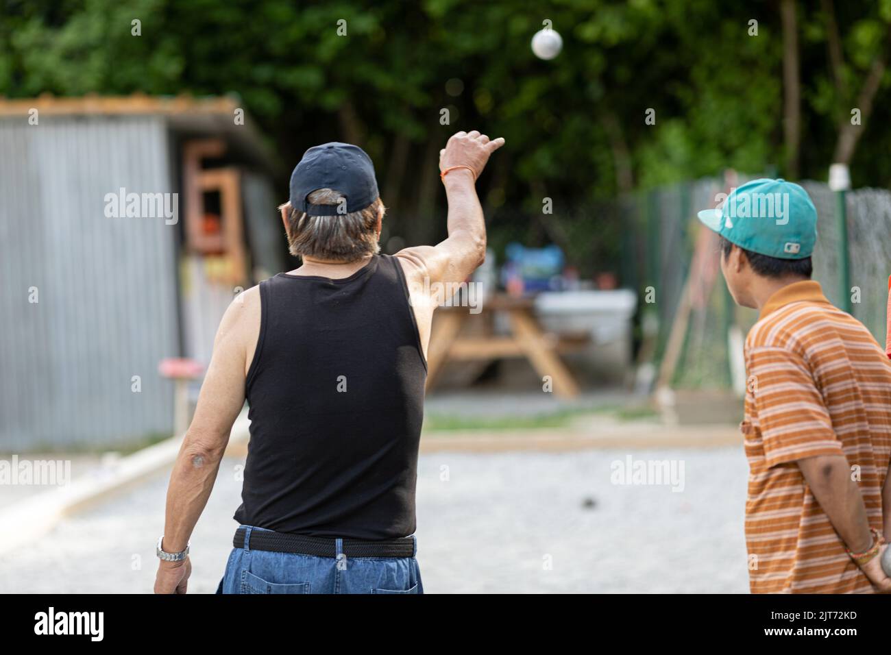 A Petanque player throwing a ball Stock Photo - Alamy