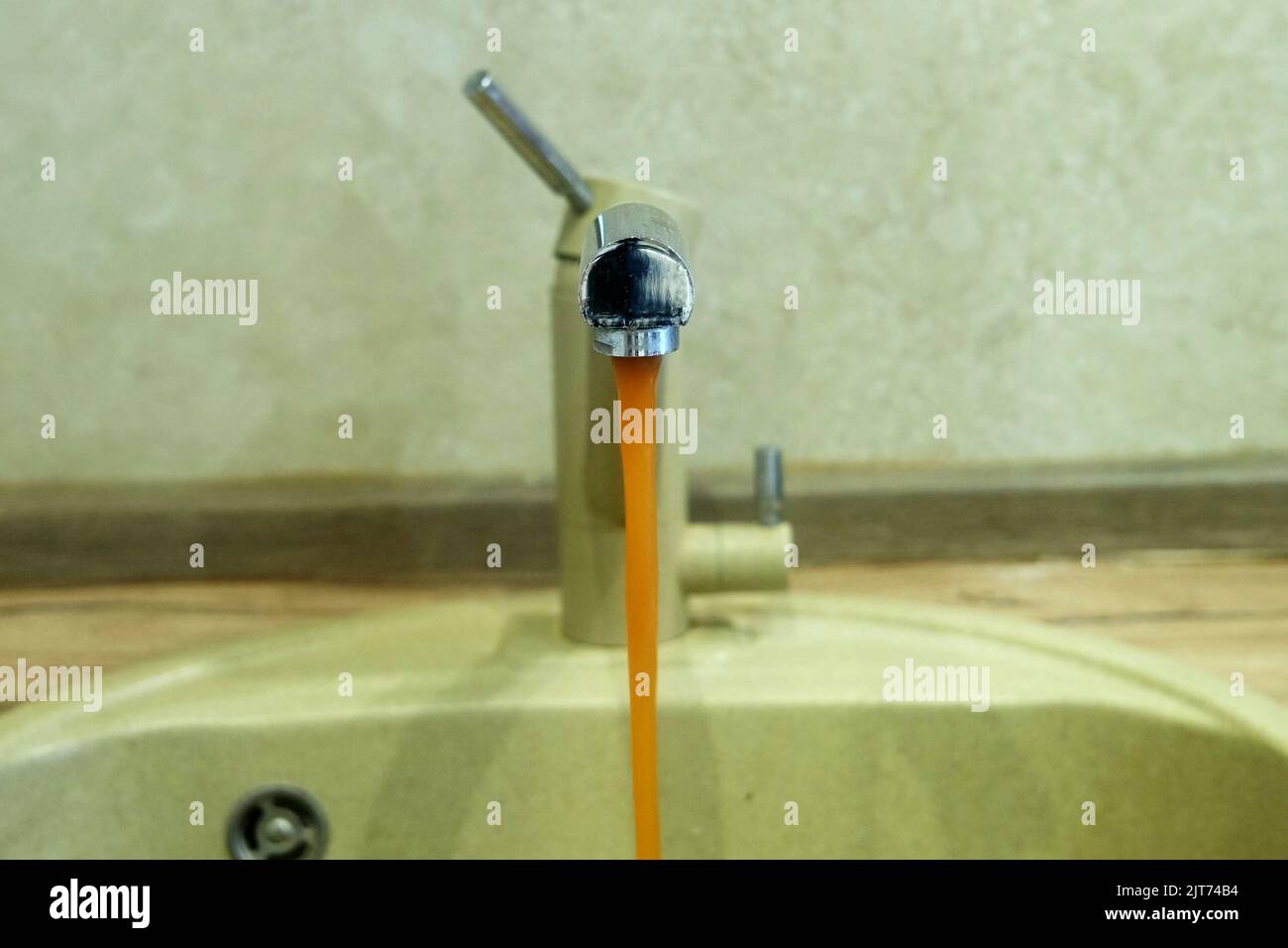 Rusty dirty water flows in a home sink from a faucet Stock Photo - Alamy