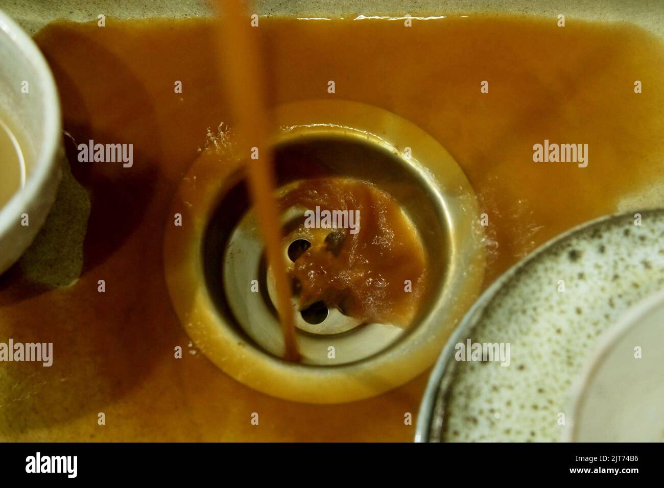 Rusty dirty water flows in a home sink from a faucet Stock Photo - Alamy