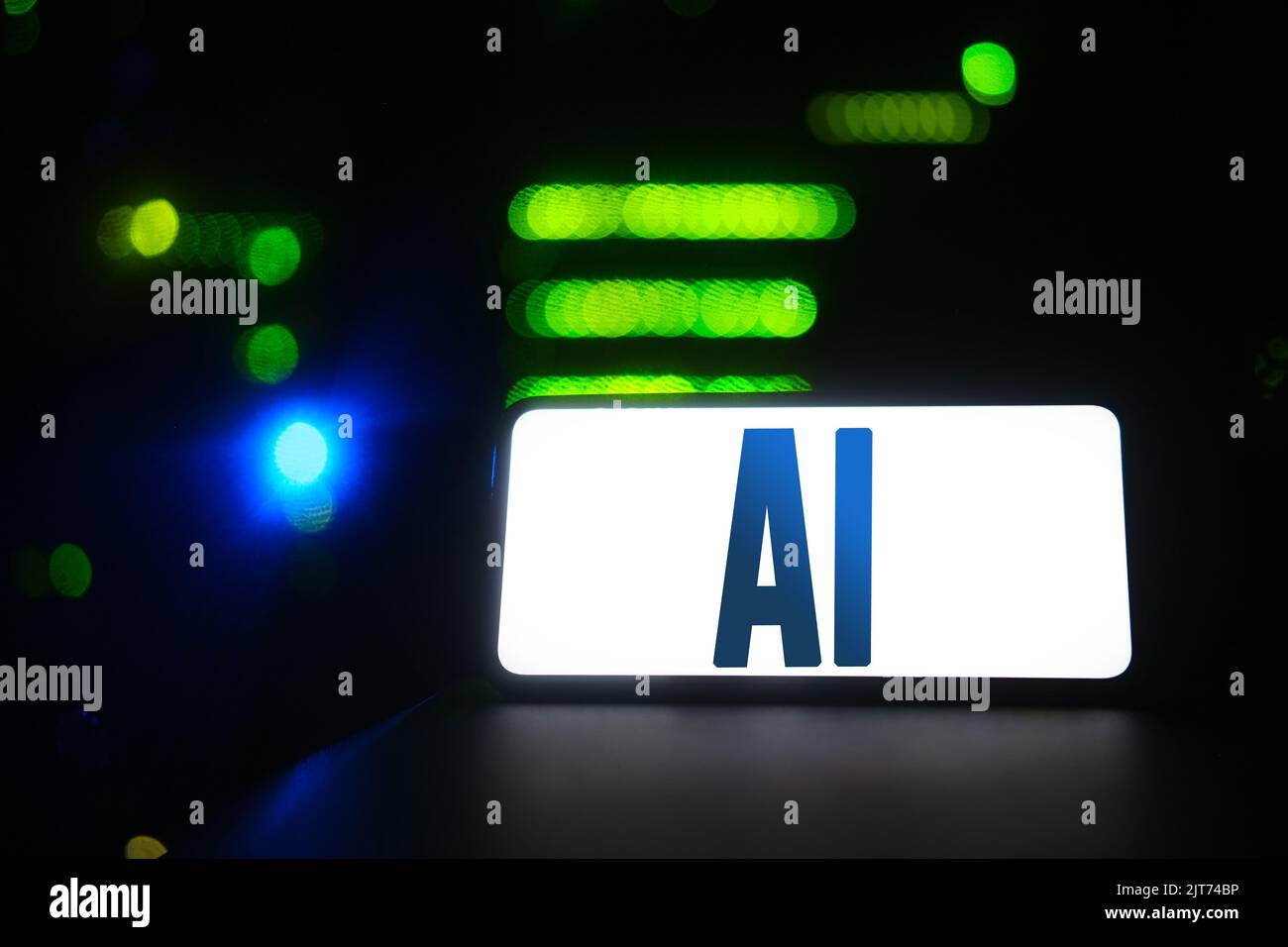 AI logo on the phone screen on the background of the server room. Smartphone with artificial ...