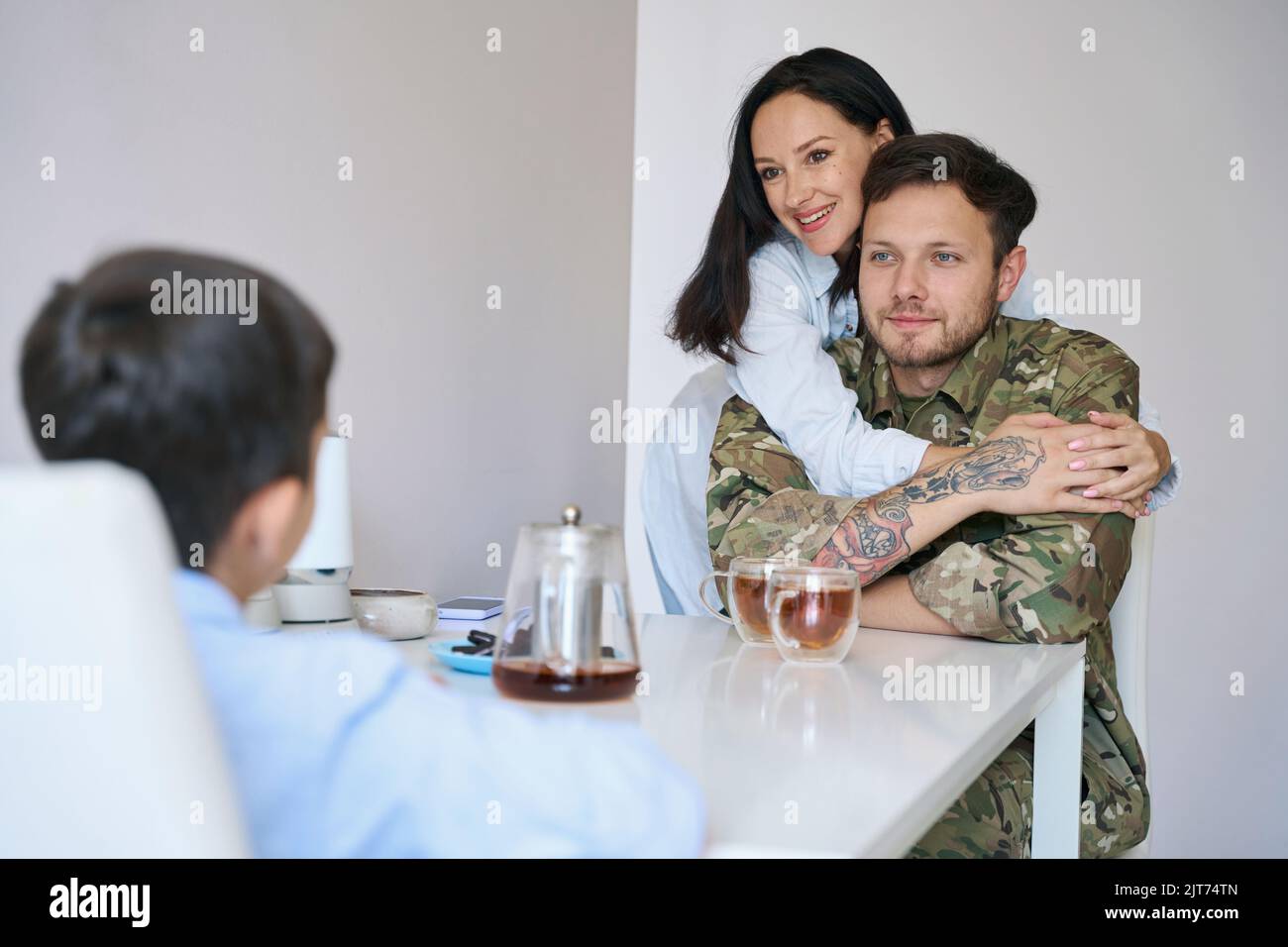 Military man at home having morning tea with family Stock Photo - Alamy