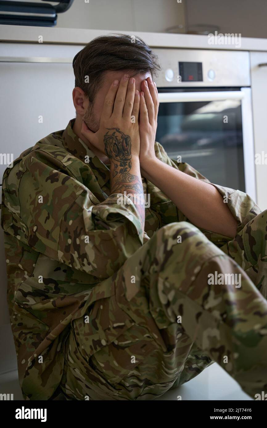 Soldier in despair covered his face with his hands Stock Photo - Alamy