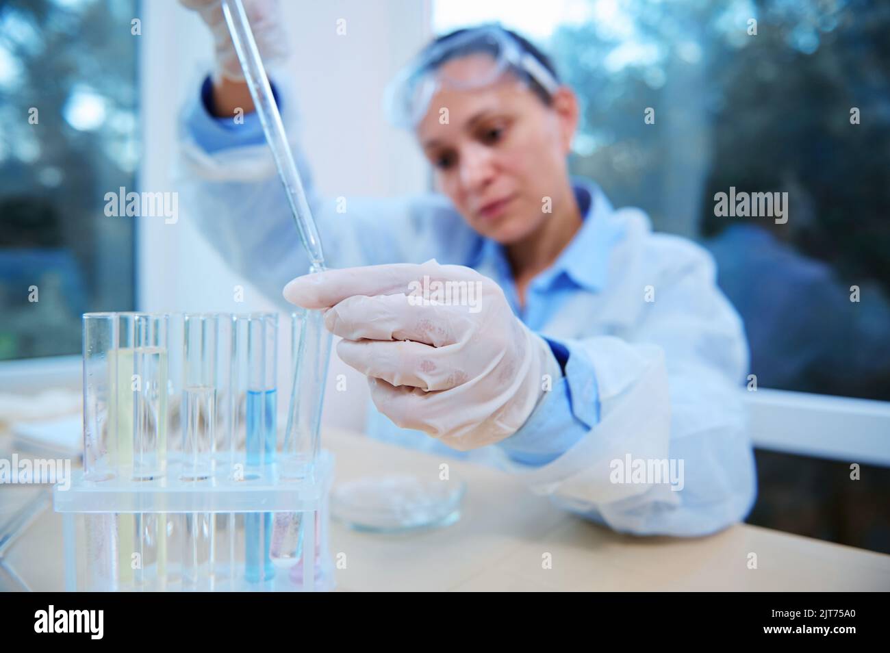 Chemist scientist laboratory asistant using a graduated pipette ...
