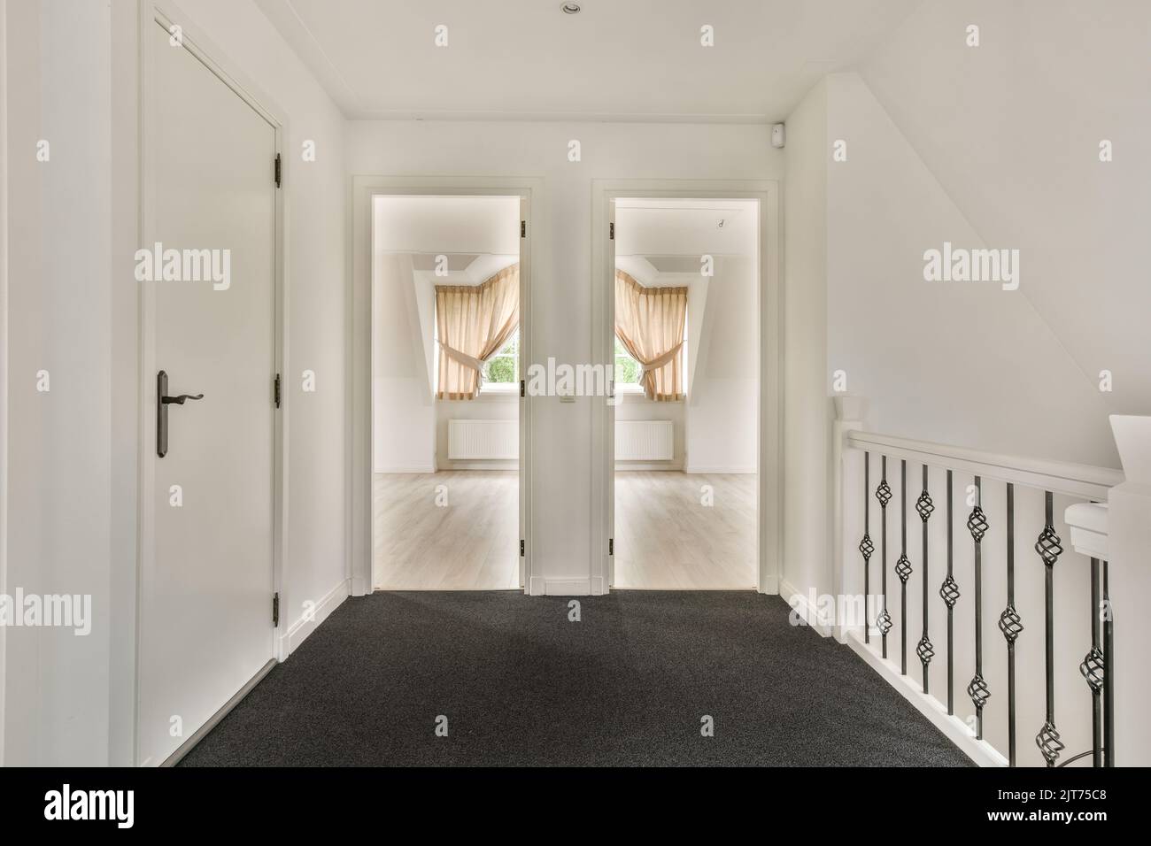 Interior of narrow corridor with many doors and staircase Stock Photo ...