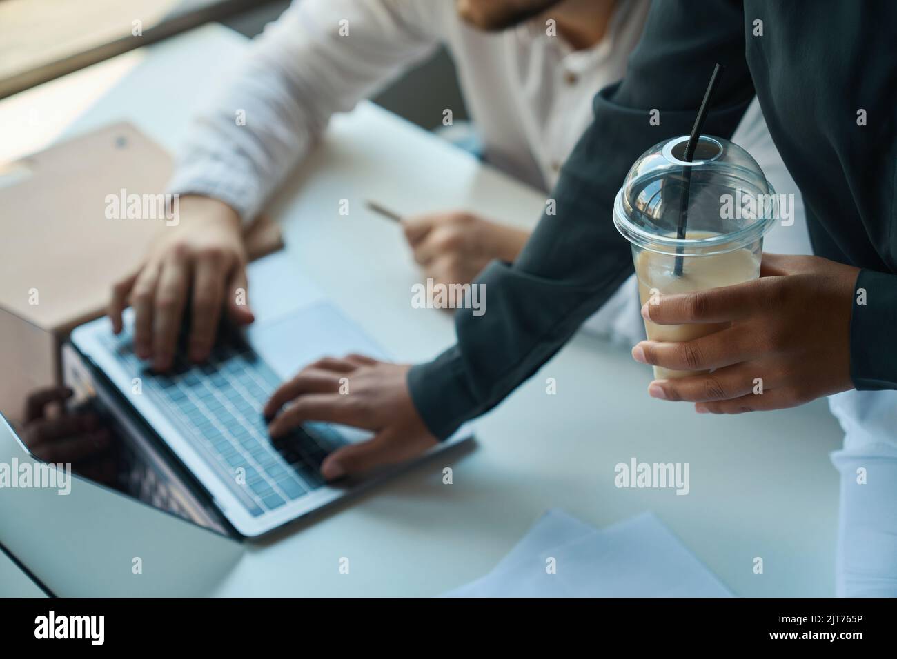 Multiracial female and caucasian men working on keyboard at desktop ...