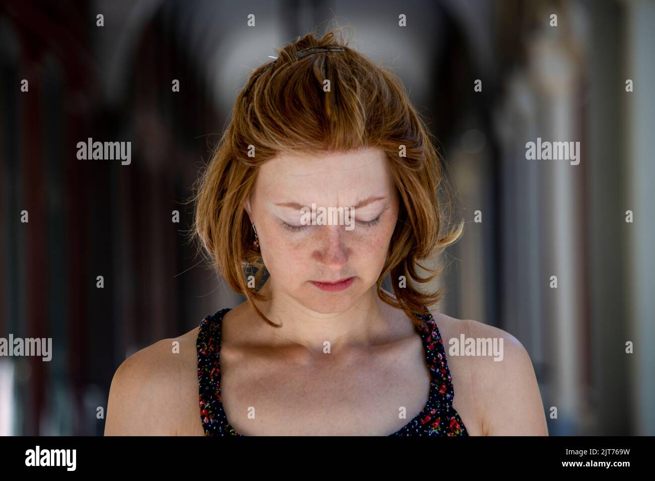 Headshot of a young blond woman looking down Stock Photo - Alamy
