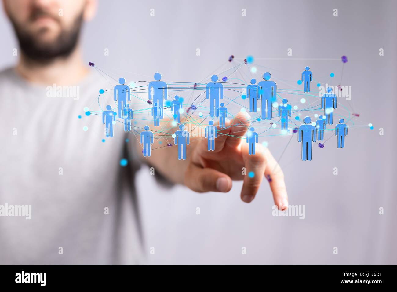 A person touching 3D rendered people icons Stock Photo - Alamy