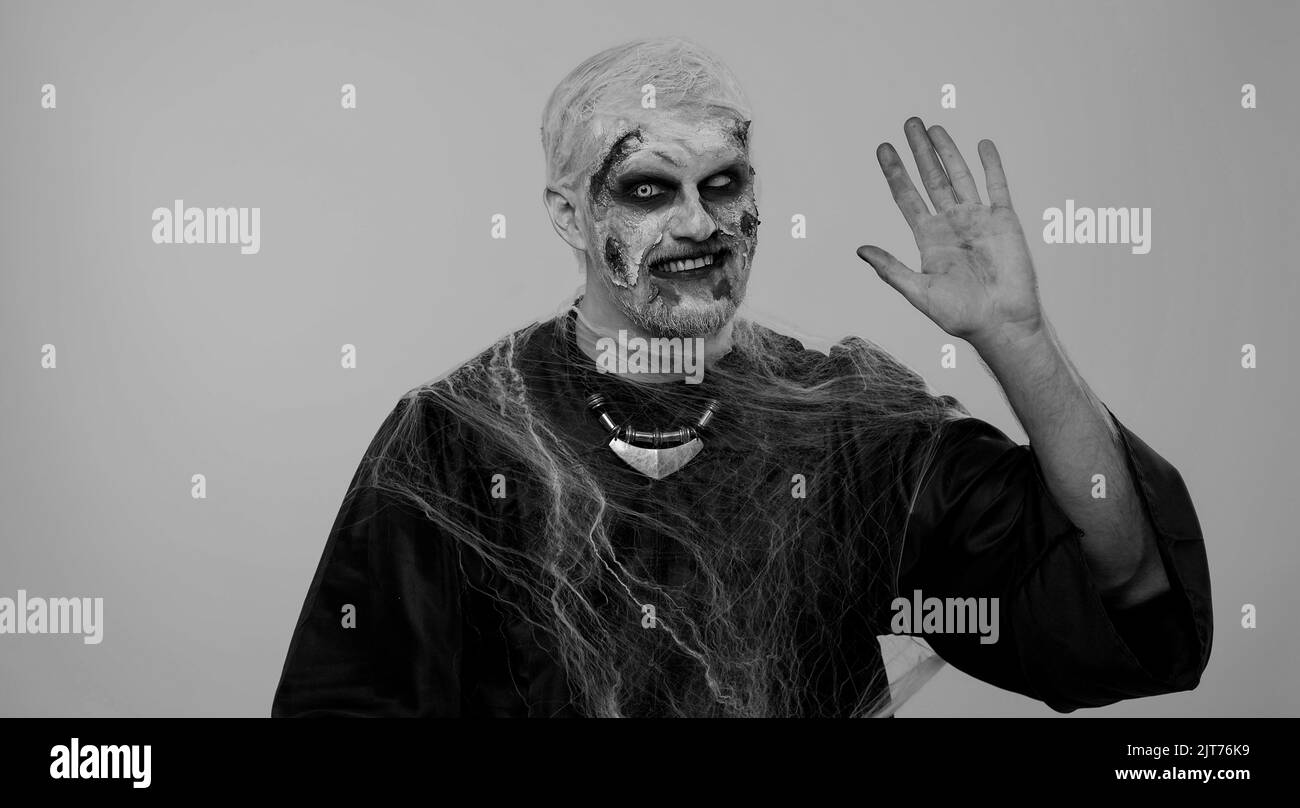 Creepy man with bloody scars face, Halloween zombie make-up. Scary ...