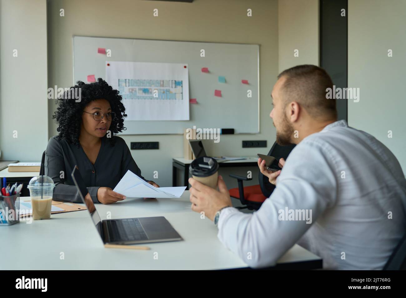 Colleagues in the office discussing working moments Stock Photo - Alamy