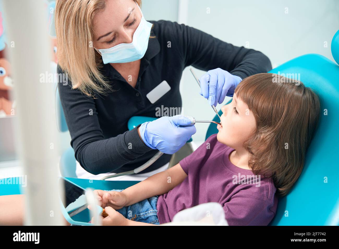 Pediatric dentist inspecting child teeth and gums Stock Photo - Alamy