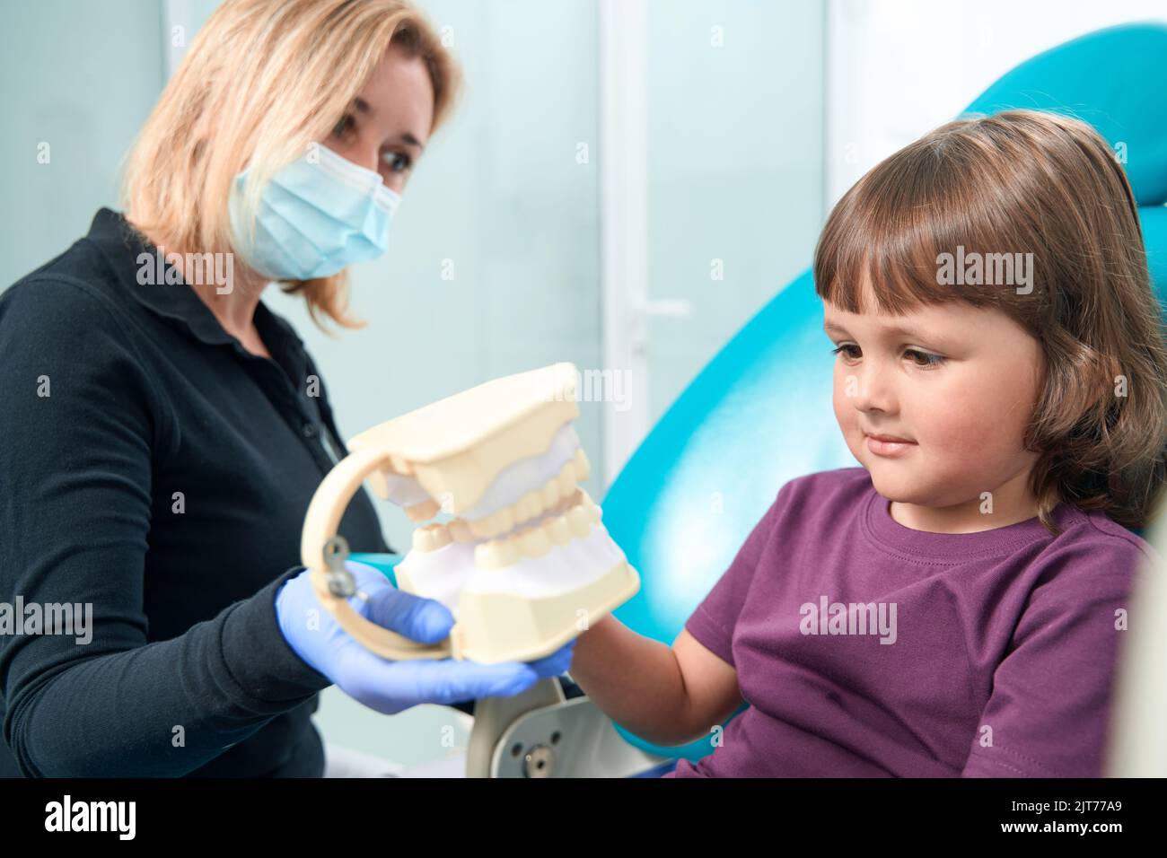 Dental hygienist giving advice on oral hygiene to little girl Stock ...
