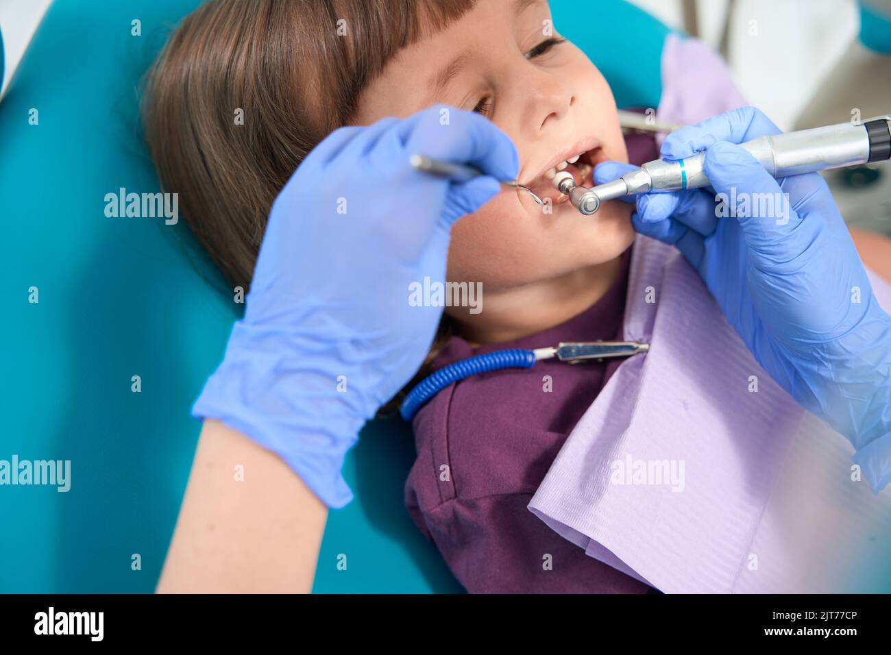 Pedodontist conducting dental procedure on little girl Stock Photo - Alamy