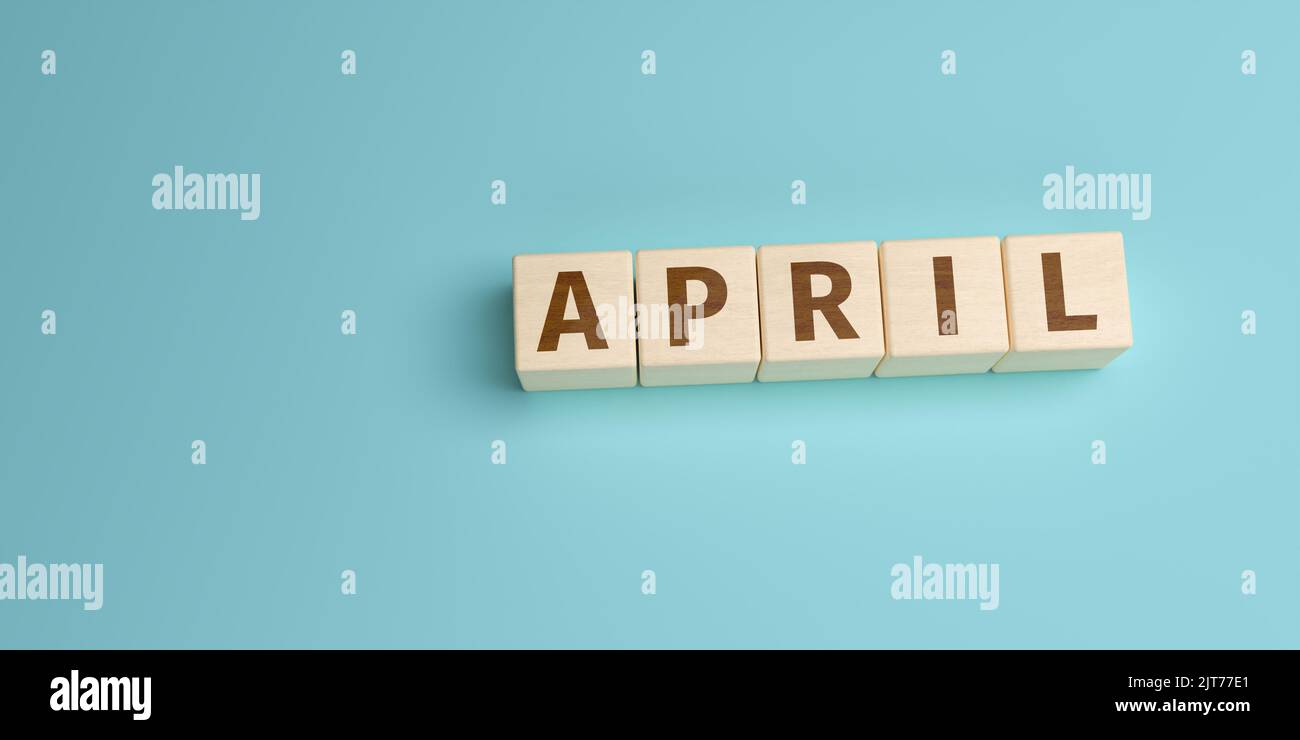 The word April built from letters on wooden cubes. High angle view with ...
