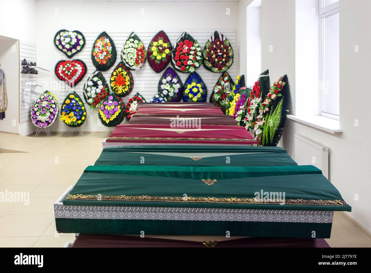 Interior of room with funeral accessories. Shop selling coffins ...